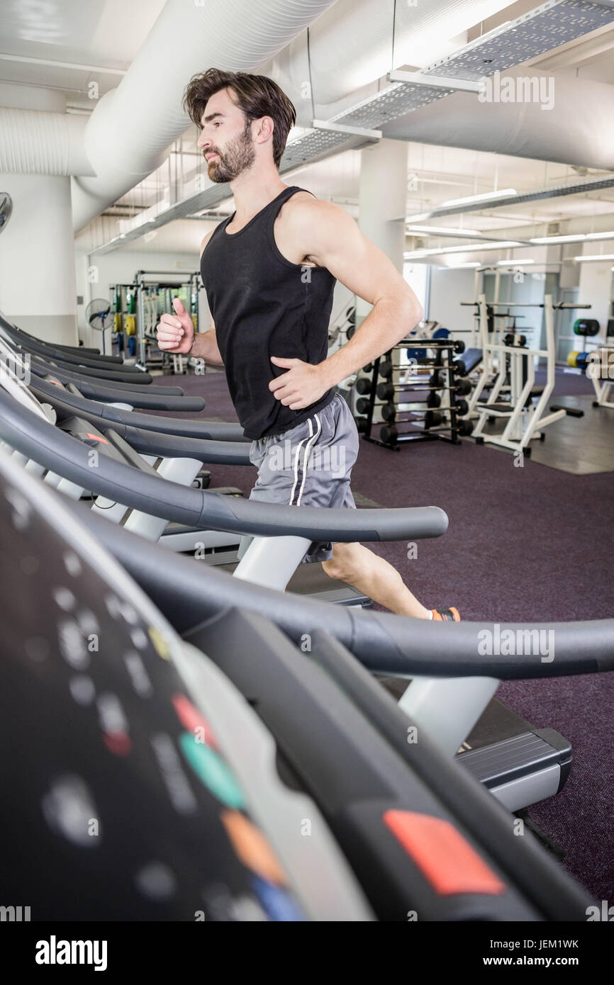 Handsome man running on treadmill Stock Photo - Alamy