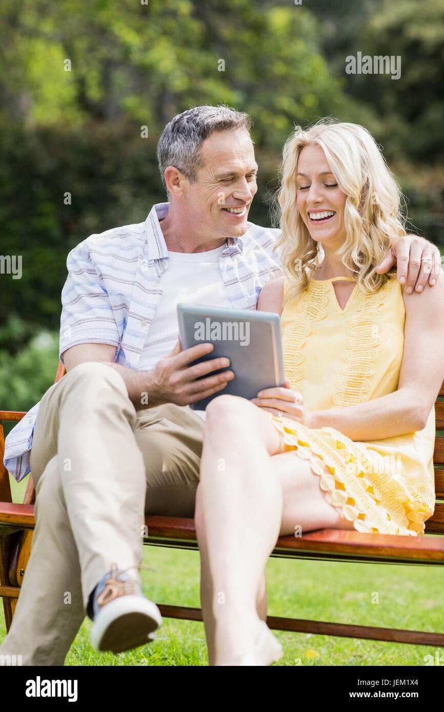 Happy couple using tablet Stock Photo - Alamy