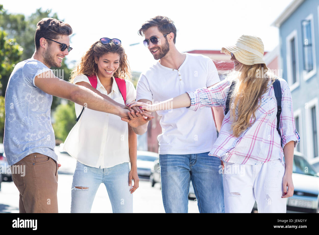 Hip friends putting hands together Stock Photo - Alamy