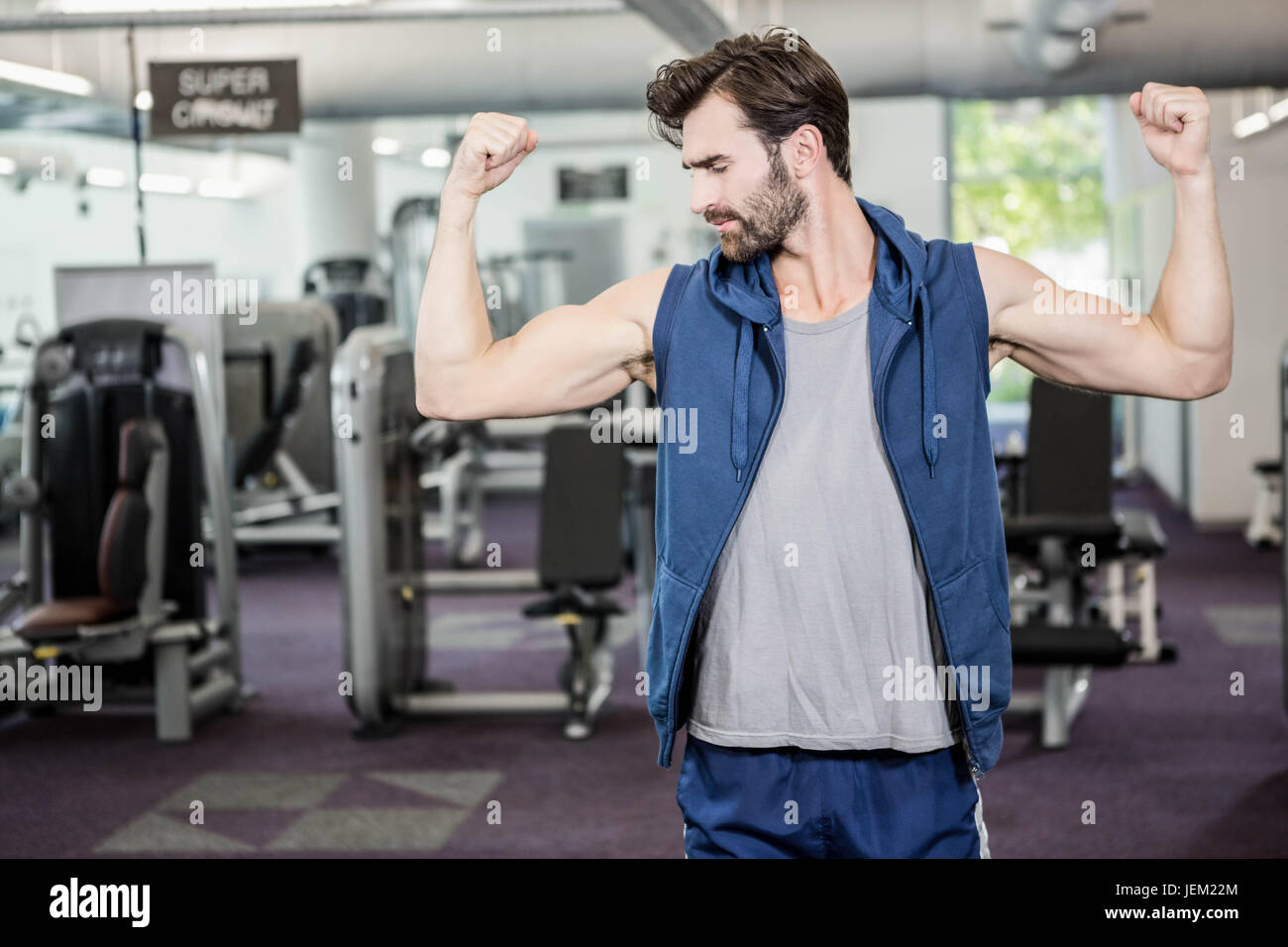 Muscular man showing biceps Stock Photo - Alamy