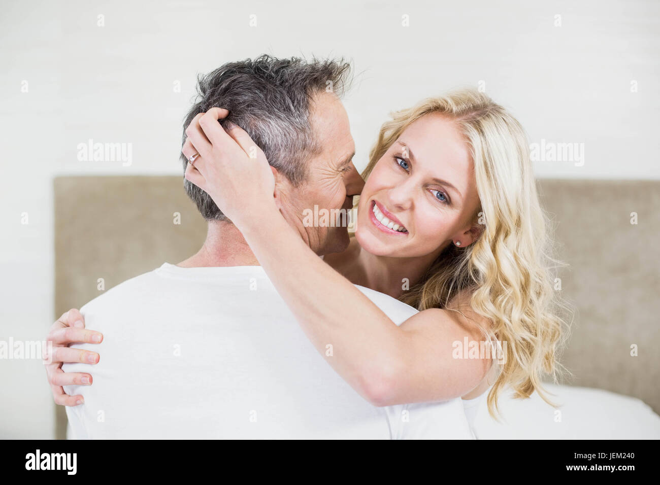 Cute couple cuddling in bed Stock Photo - Alamy