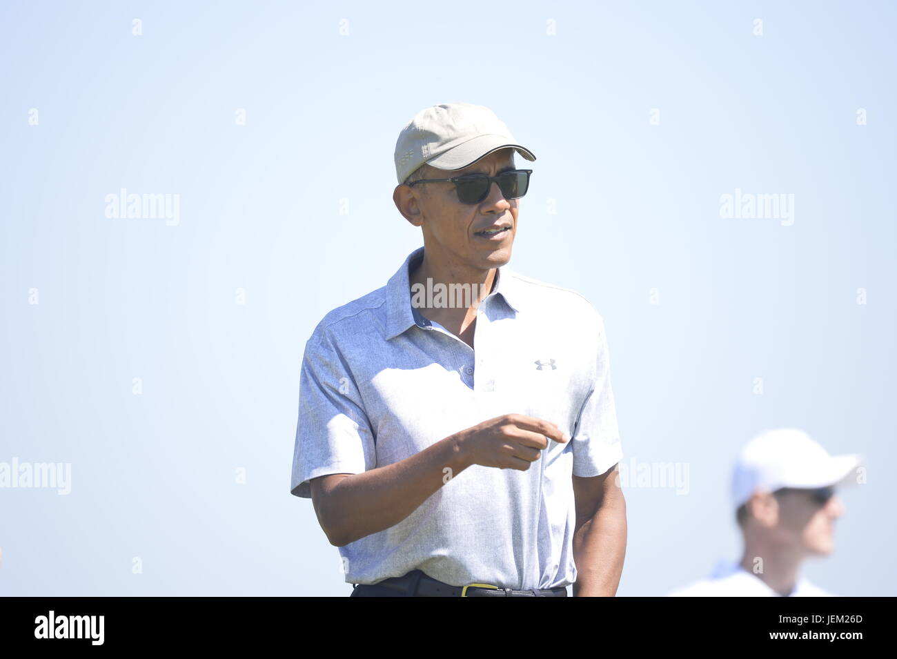 Former US president Barack Obama (light blue shirt) playing a round of ...