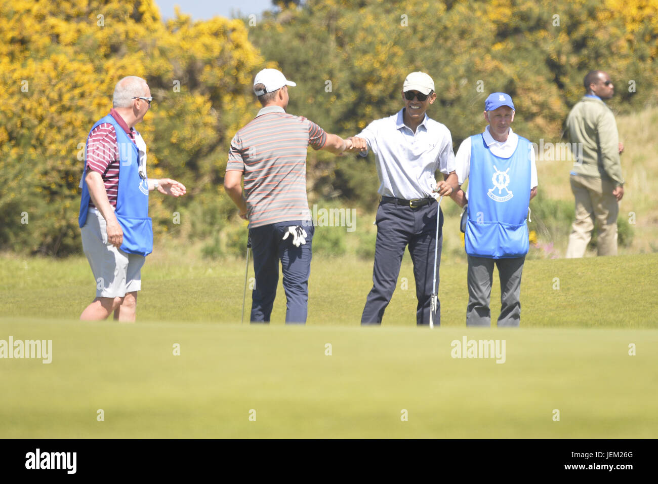 Former US president Barack Obama (light blue shirt) playing a round of ...
