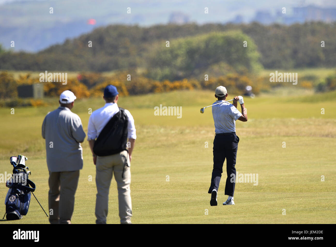 Former US president Barack Obama (light blue shirt) playing a round of ...