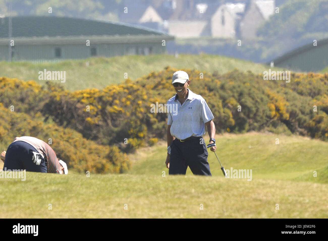 Former US president Barack Obama (light blue shirt) playing a round of ...