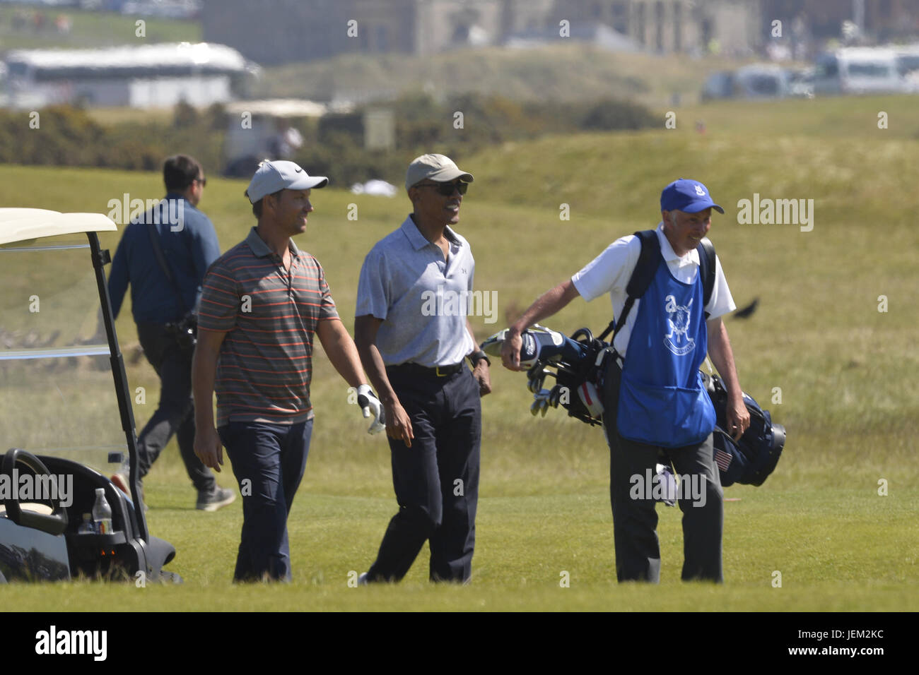 Former US president Barack Obama (light blue shirt) playing a round of ...