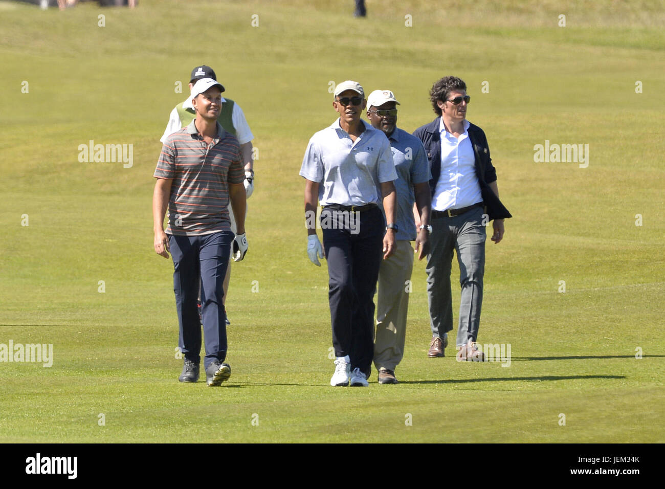 Former US president Barack Obama (light blue shirt) playing a round of ...