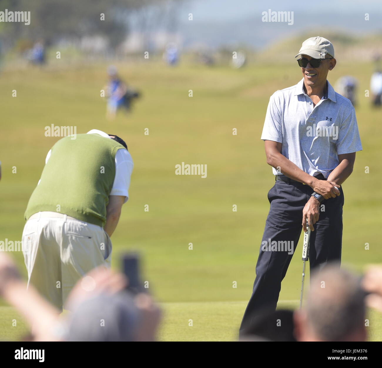Former U.S. president Barack Obama (light blue shirt) playing a round ...