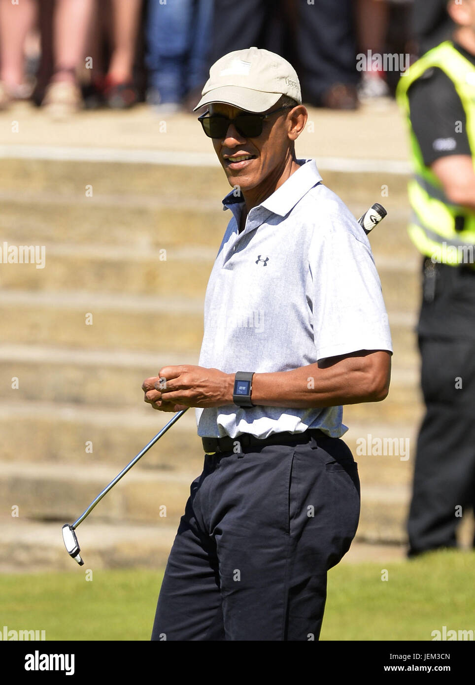 Former U.S. president Barack Obama (light blue shirt) playing a round ...