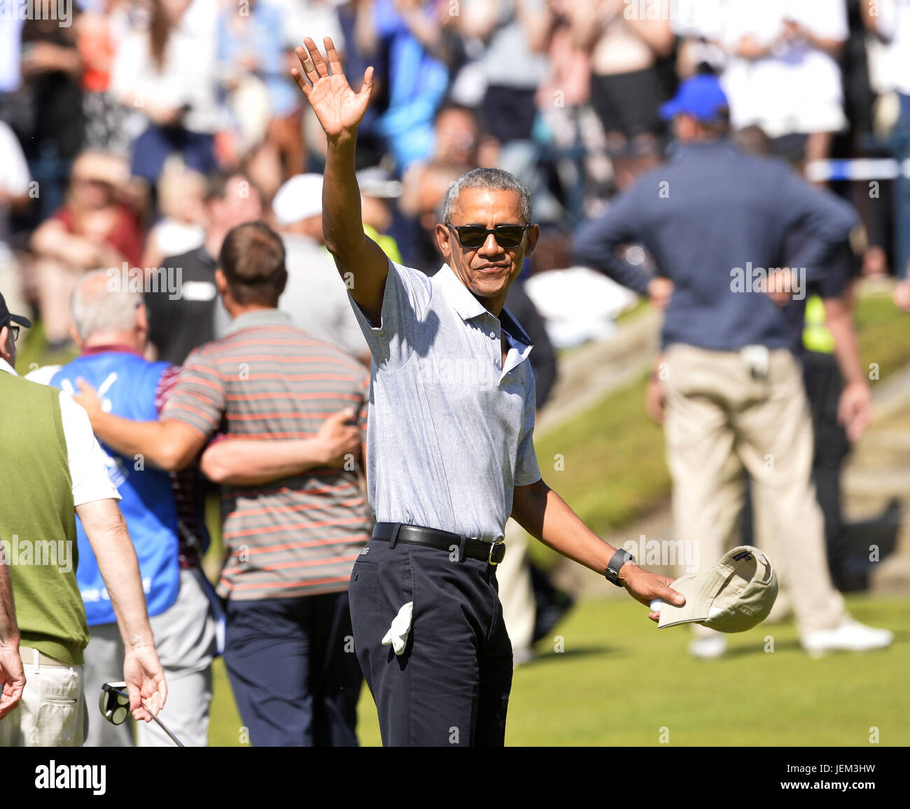 Former U.S. president Barack Obama (light blue shirt) playing a round ...