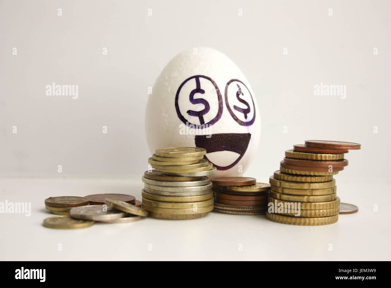 Business concept money. A very happy egg with coins. Photo for your ...