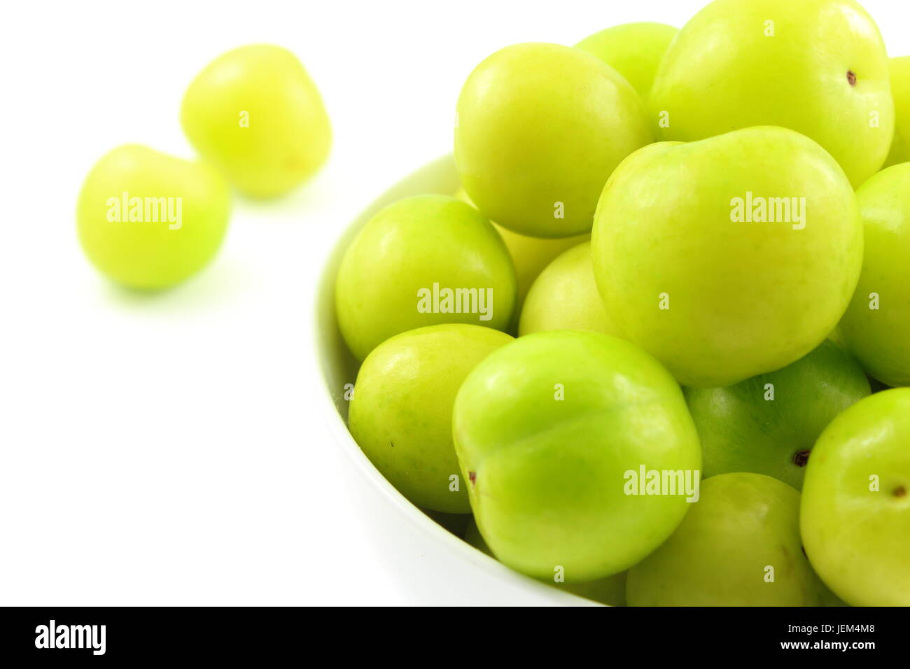 composition of fresh turkish can erik plum fruits in a small white bowl ...