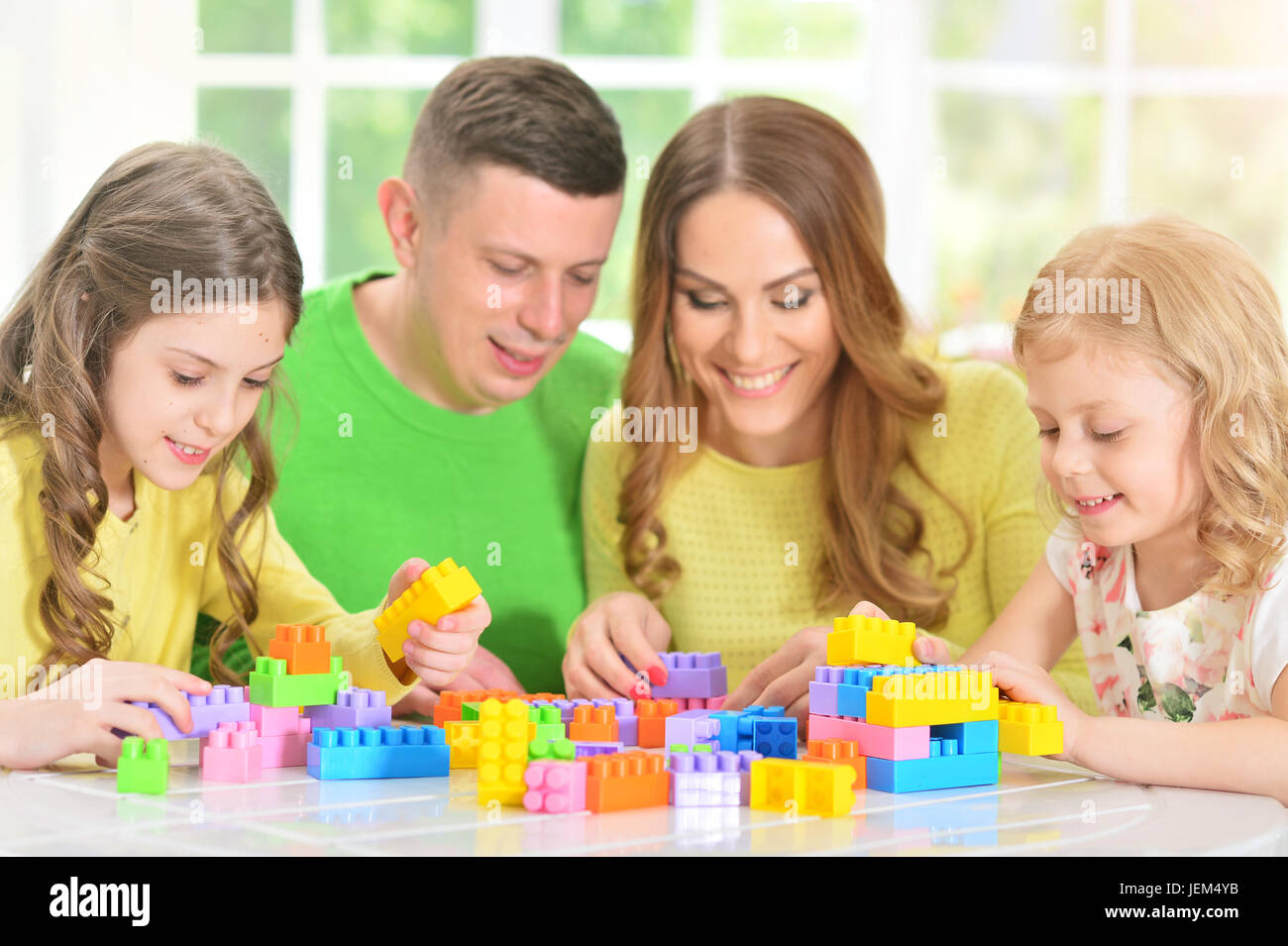 Family collecting blocks together Stock Photo - Alamy