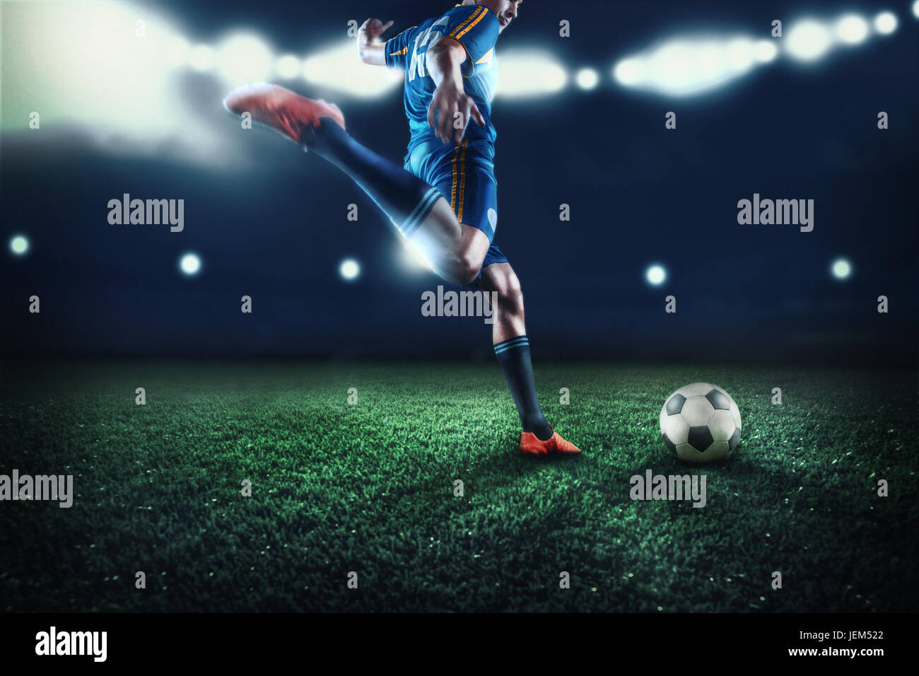 The active player of football at stadium in motion Stock Photo - Alamy
