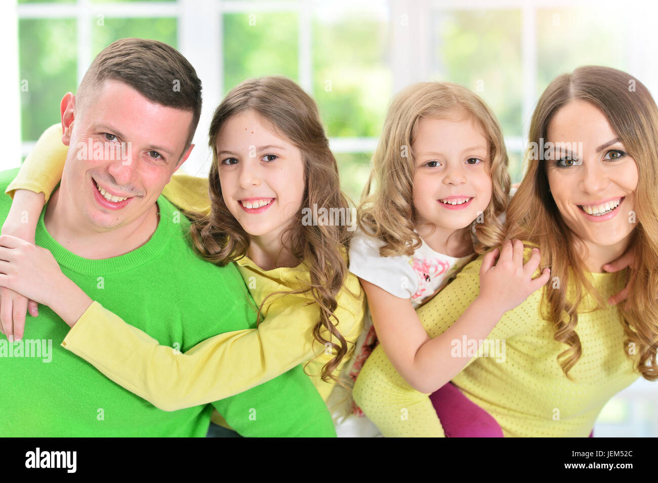 Happy family of four standing Stock Photo - Alamy