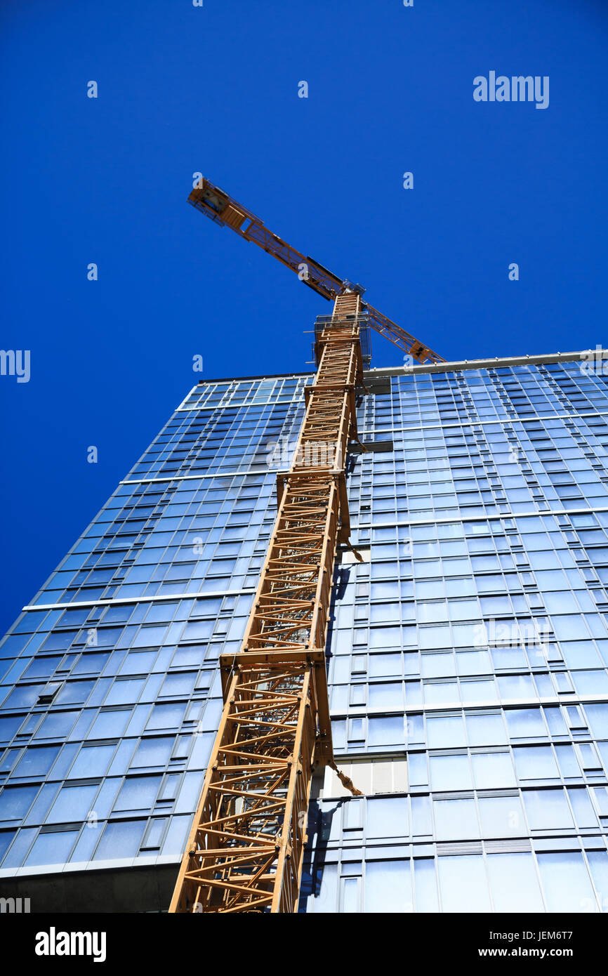 Yellow Crane up Blue Tower Construction Project Stock Photo - Alamy