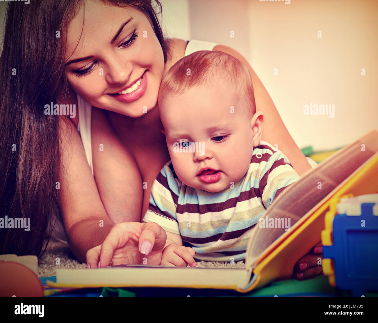 Family book read with mother and baby. Early reading develops children ...