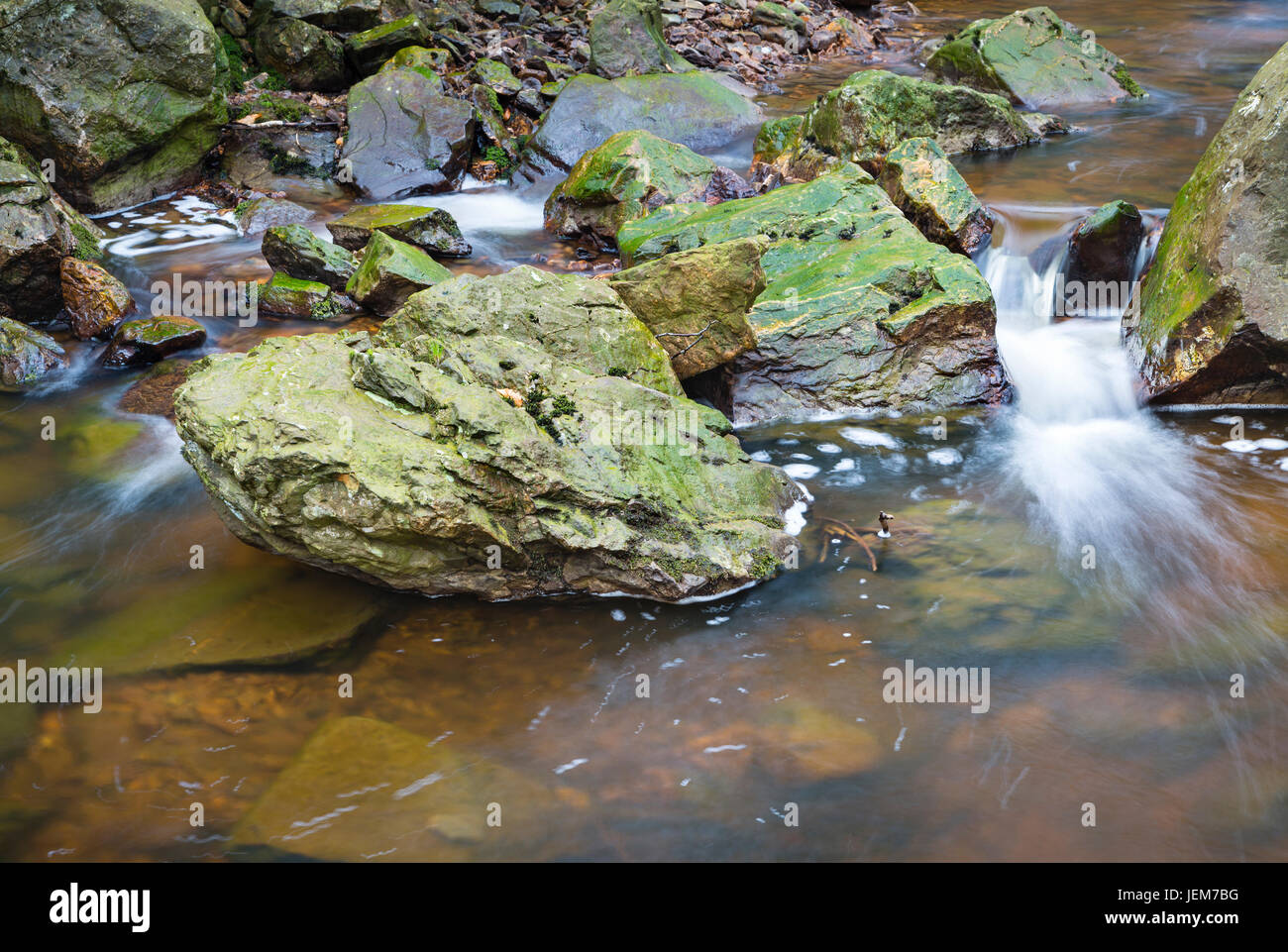 Brown River Between Green Rocks Stock Photo - Alamy