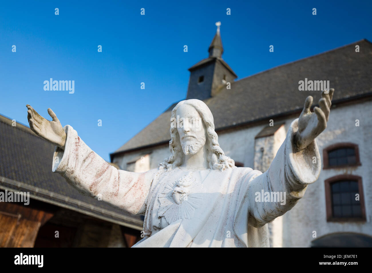 A statue of Jesus in front of the Monastery Reichenstein in the Rur ...