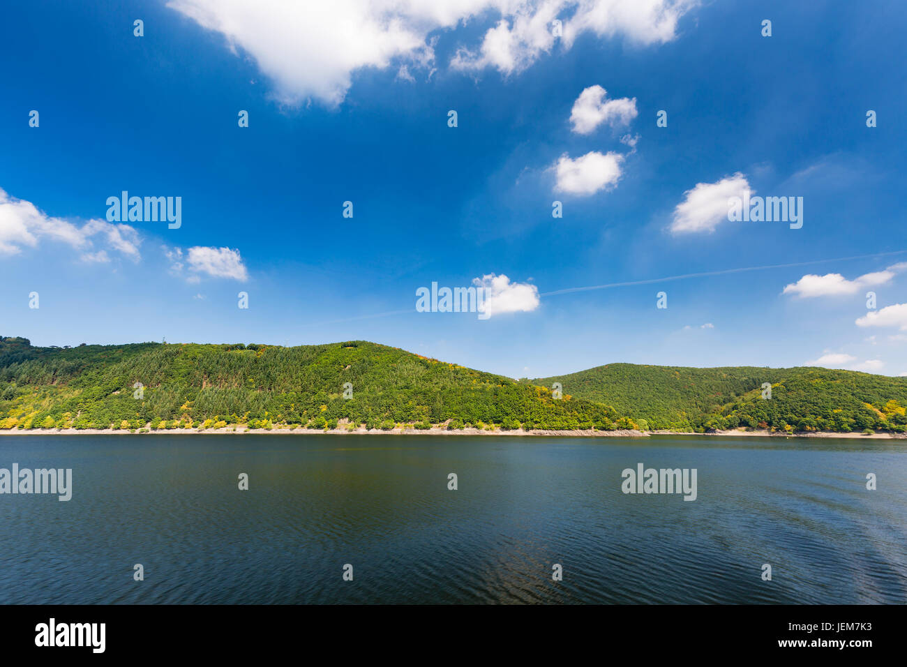 Shore and hills around Lake Rursee with perfect blue sky and sunlight ...