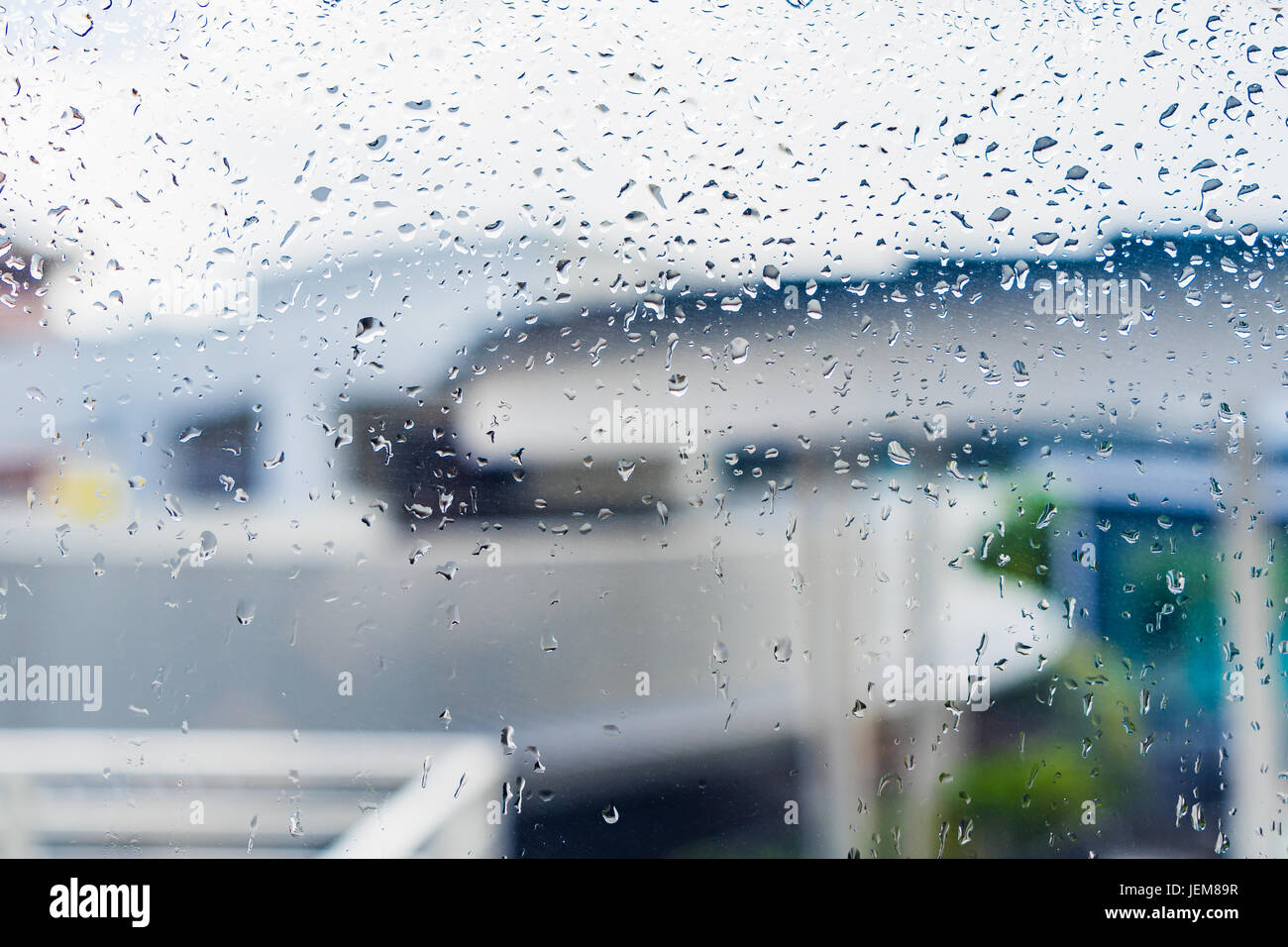 Drops of rain on a window glass, Through the window view of overcast ...
