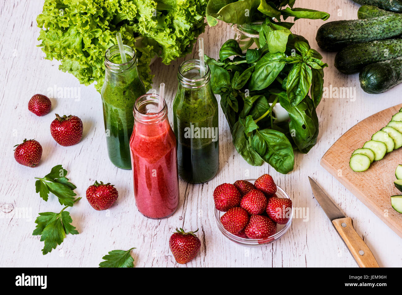 Fresh green smoothies and strawberry smoothie with ingredients on a ...