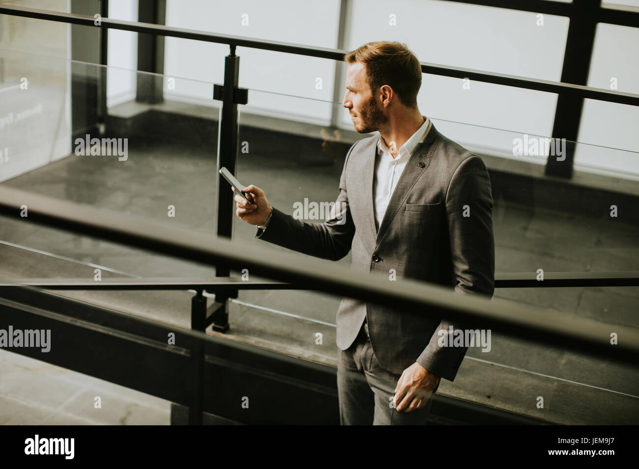 View at Young successful men entrepreneur using mobile phone outdoor ...