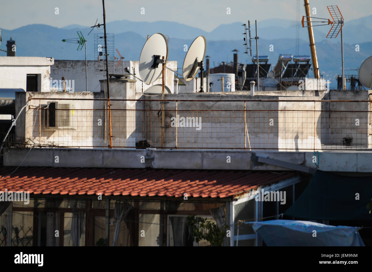 Televion aerial sand parabolic antennas on building's roof, (Athens, Greece Stock Photo - Alamy