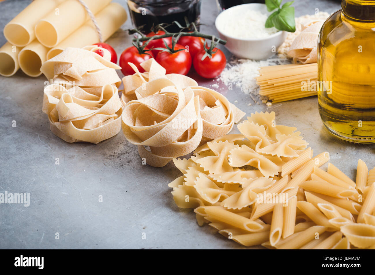 Variety of Italian pasta shapes. Cooking ingredients on gray background ...
