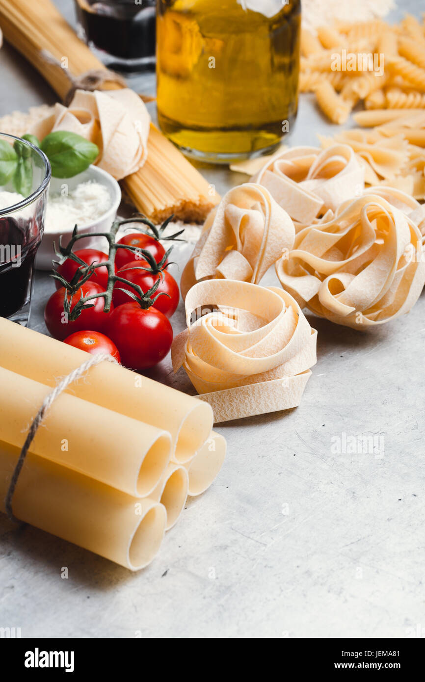 Variety of Italian pasta shapes. Cooking ingredients on gray background ...