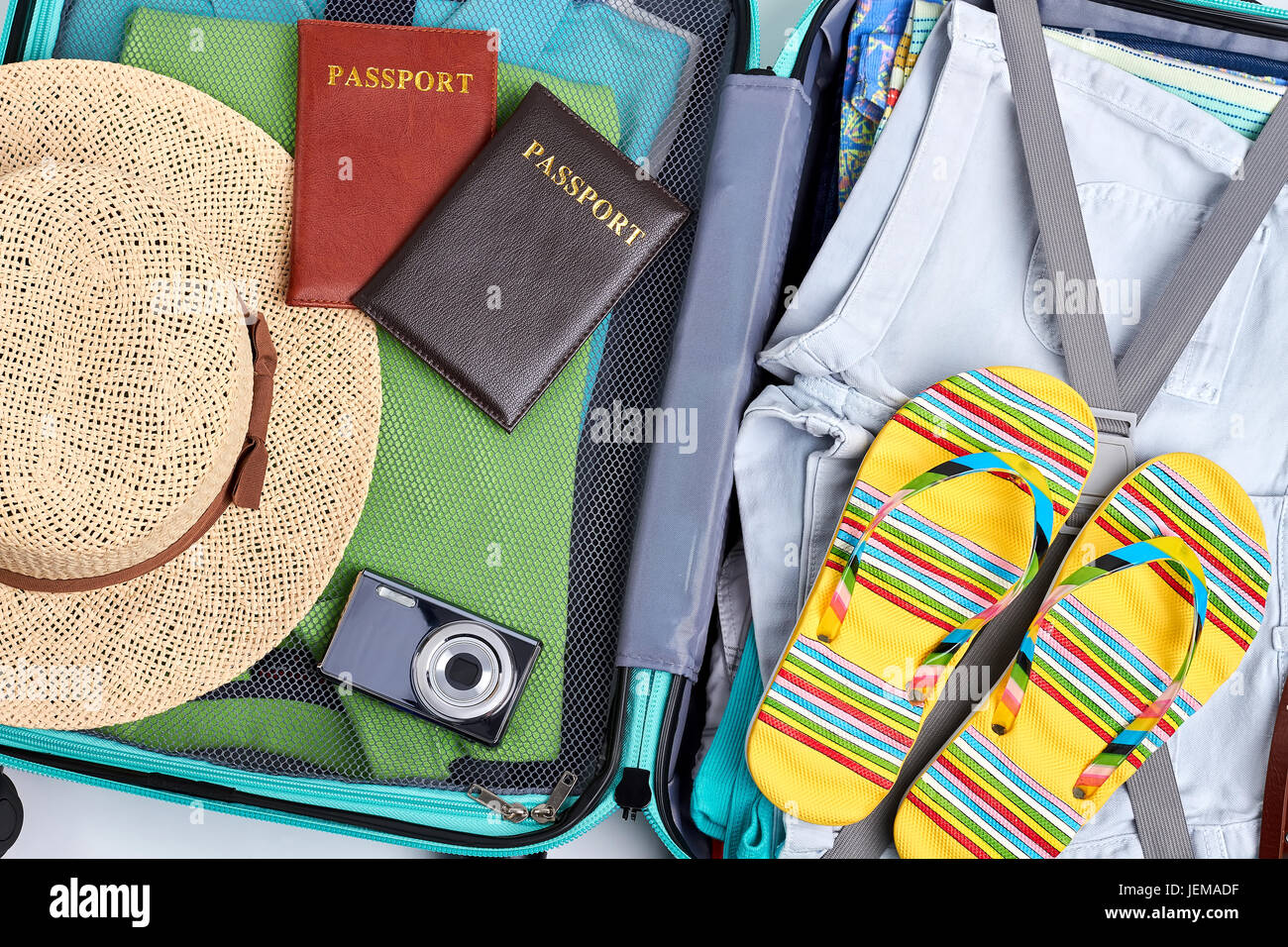 Luggage With Accessories Close Up Beach Clothes And Passports Stock