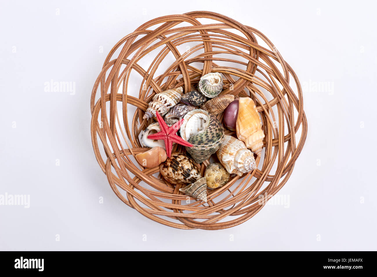 Collection of seashells in decorative basket. Ocean souvenirs in wooden ...