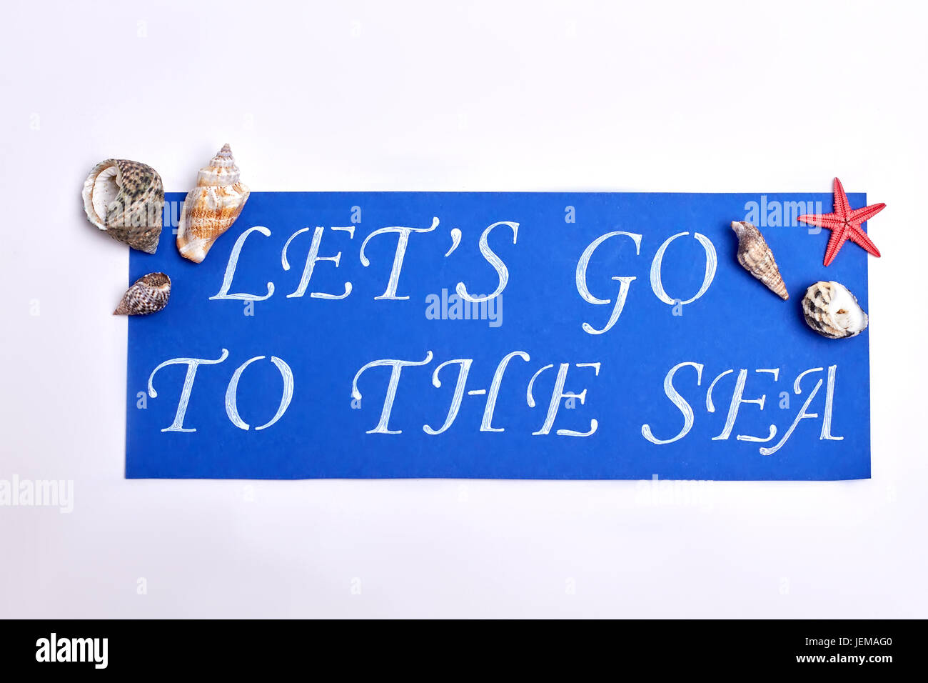 Blue paper inscription with sea concept. Note with sea shells on white ...