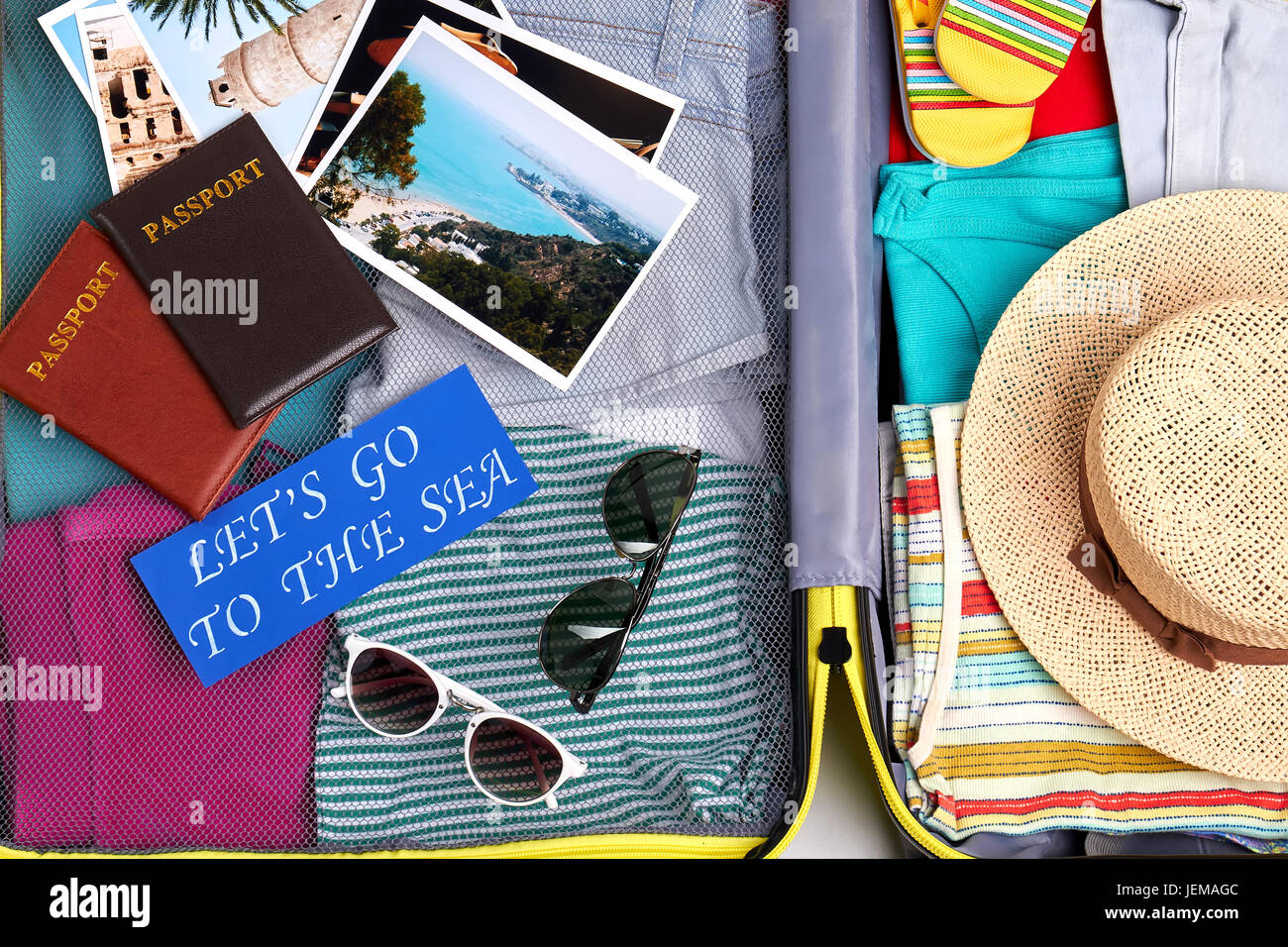 Traveler suitcase ready for trip. Full luggage of summer accessories ...