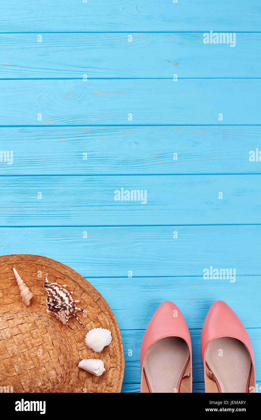 Summer vacation background, blue surface. Female sandals, straw hat ...