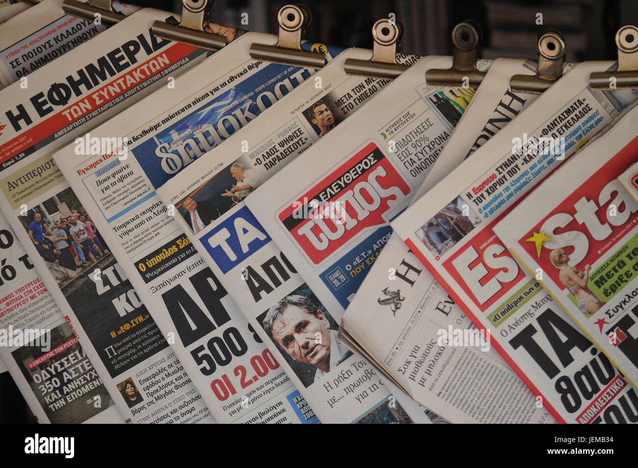 Greek newspapers on a clothesline in a newspapers shop of Piraeus ...