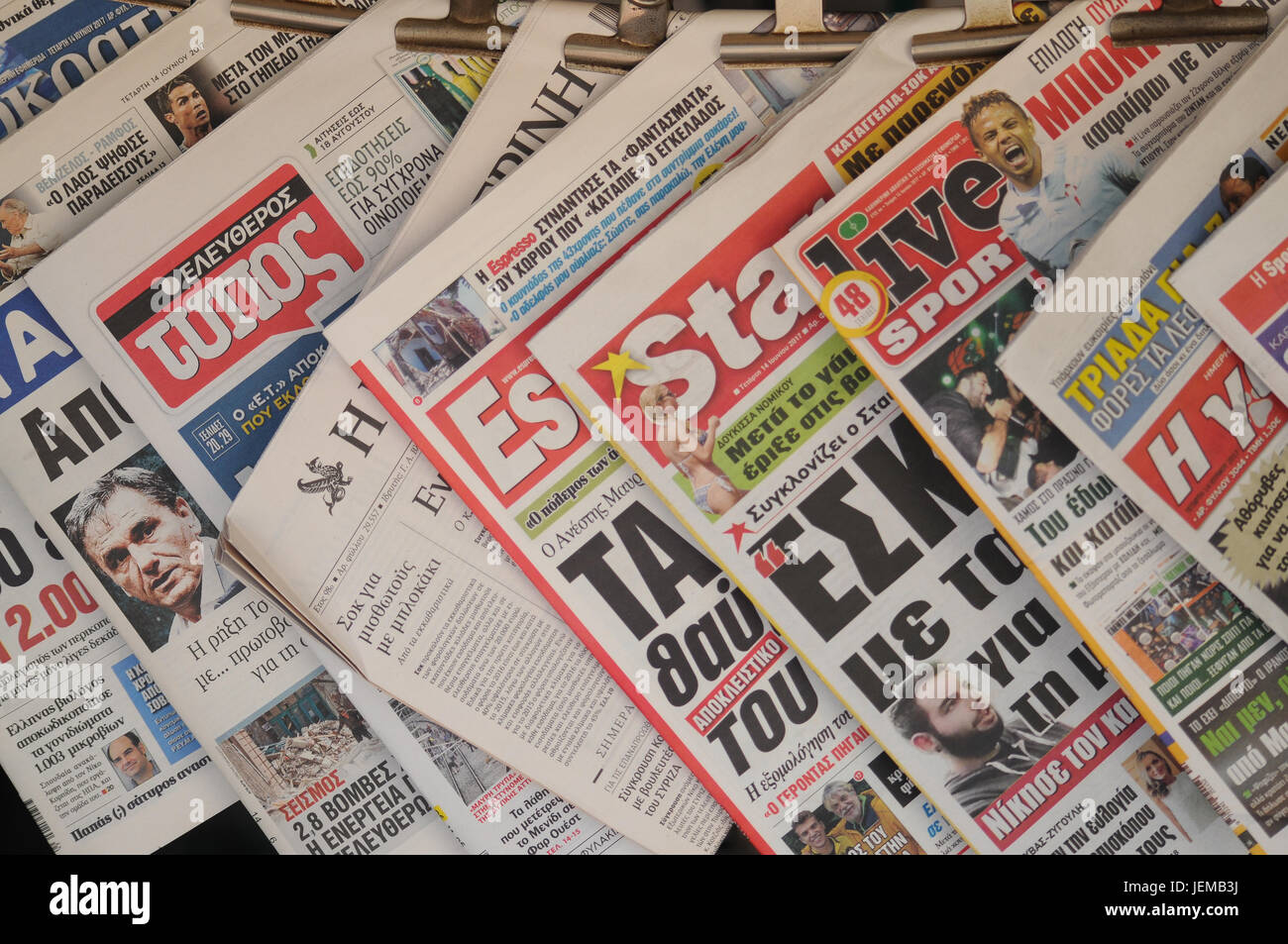 Greek newspapers on a clothesline in a newspapers shop of Piraeus ...