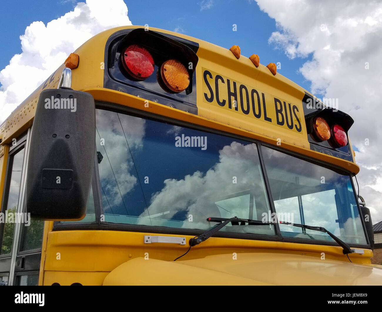 yellow school bus with cloud reflection in windshield Stock Photo - Alamy
