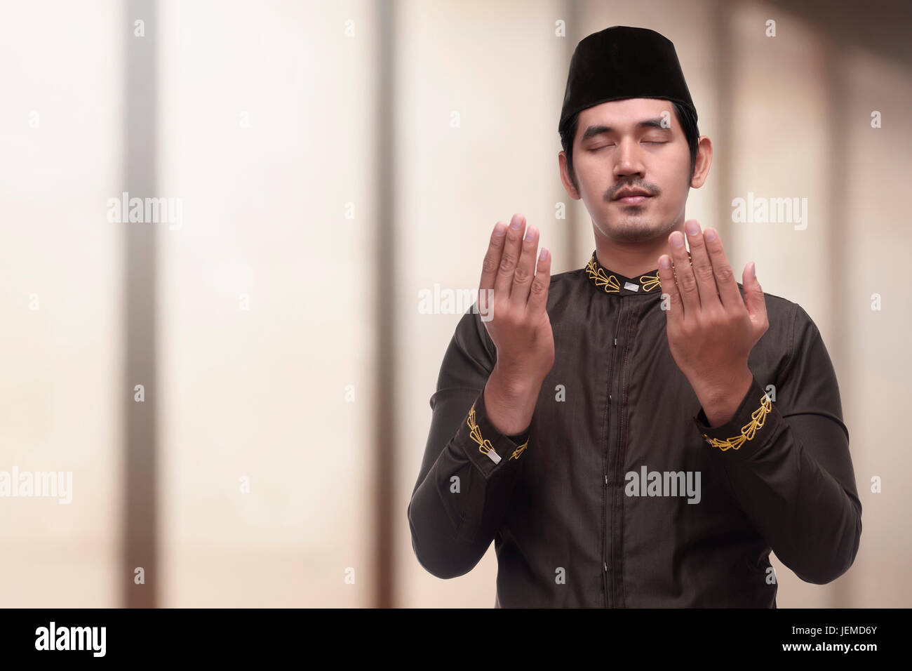 Handsome asian muslim man raising hand and praying on the mosque Stock ...