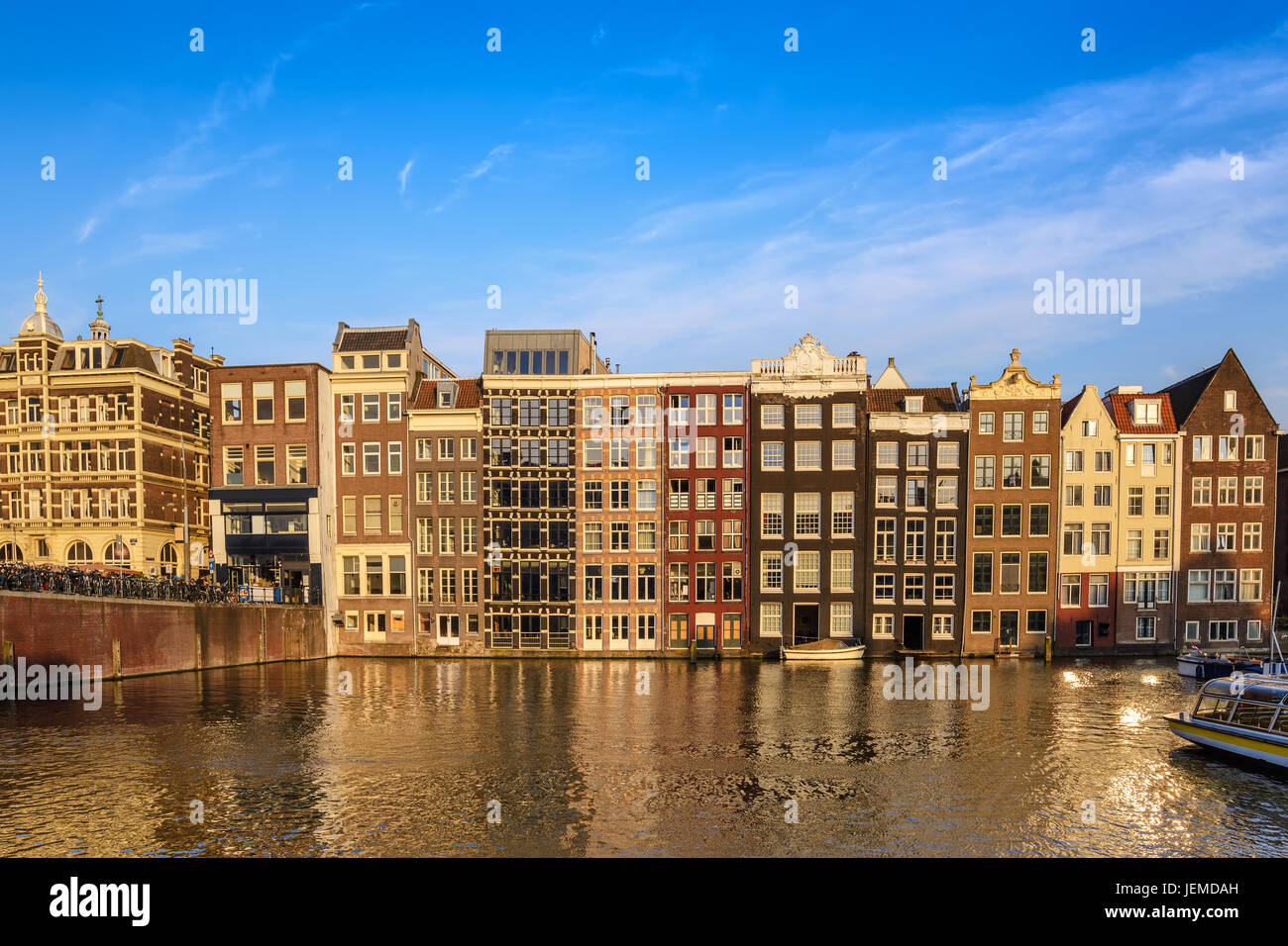 Amsterdam city skyline at Damrak canal waterfront, Amsterdam ...