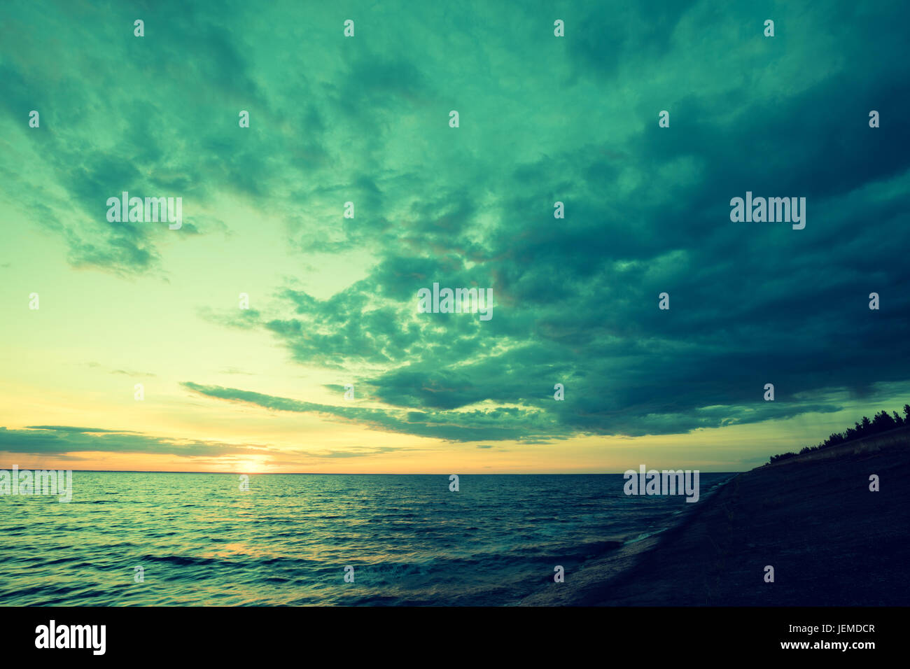 Beautiful dramatic green sunset over the sea Stock Photo - Alamy
