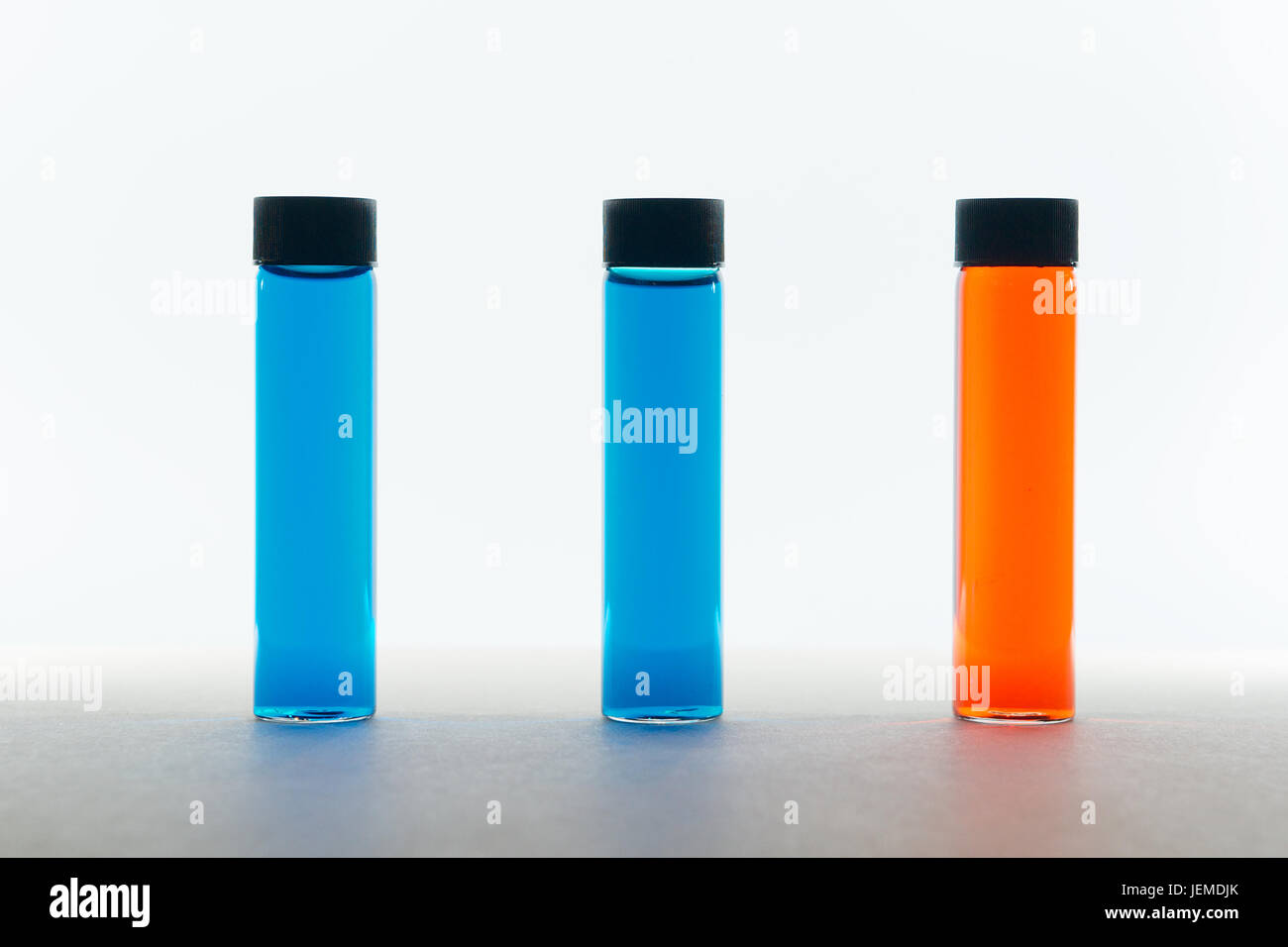 Small glass tube with a lid containing coloured liquid Stock Photo - Alamy