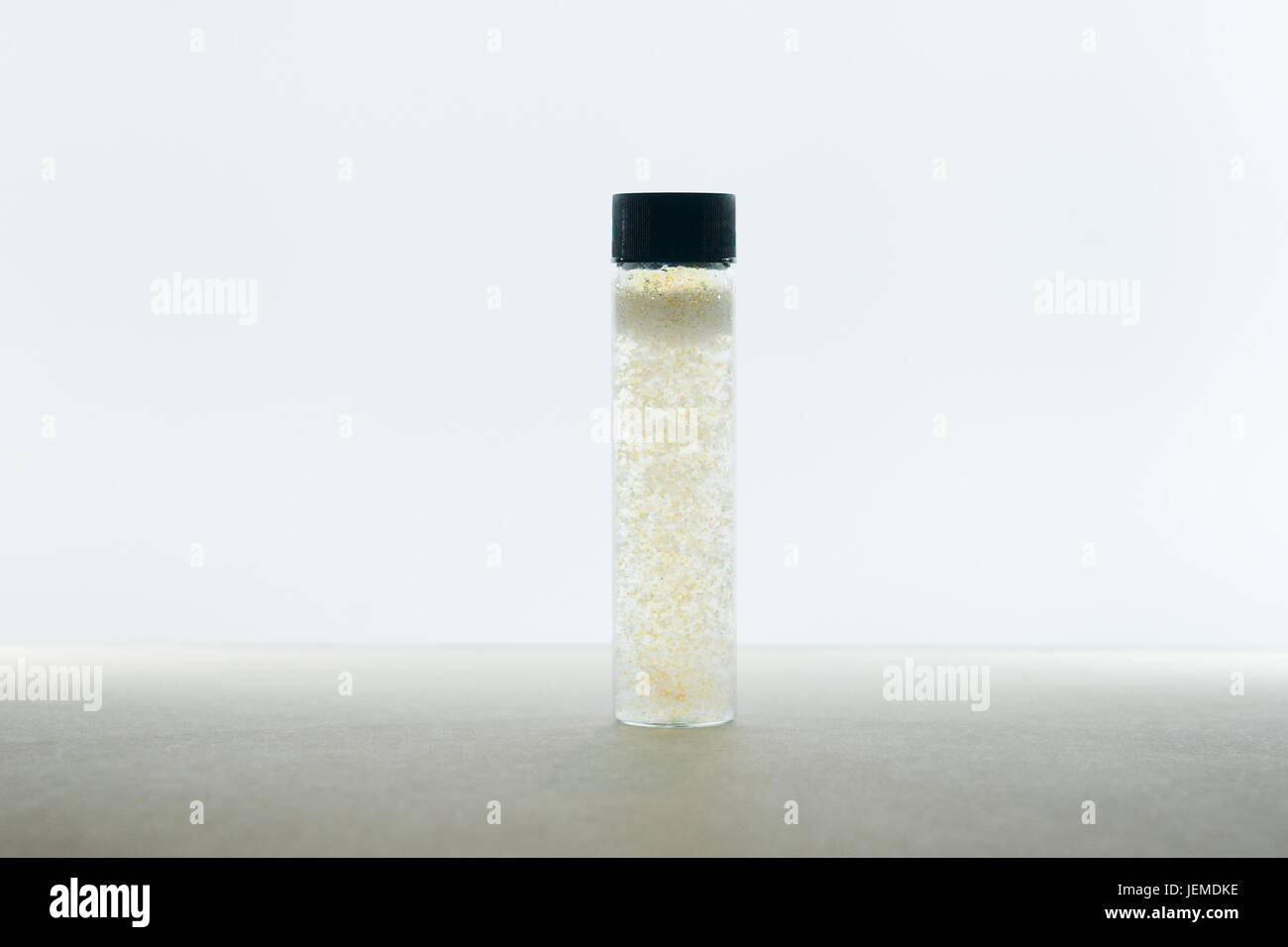 Small glass tube with a lid containing coloured liquid Stock Photo - Alamy