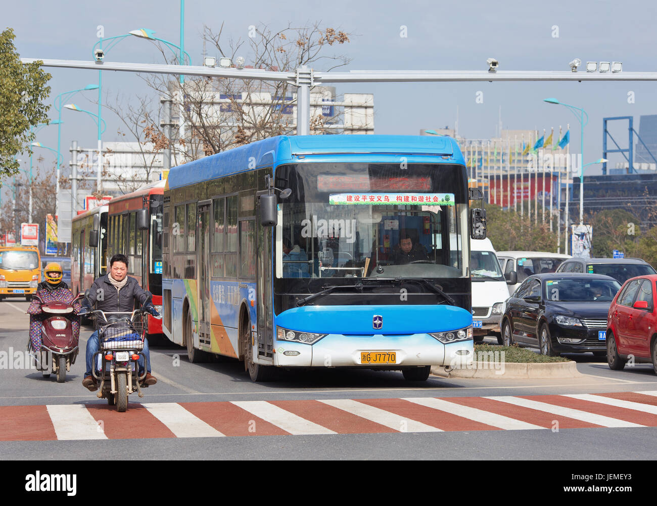 Bus waiting at traffic light. Public buses are very common in Chinese ...
