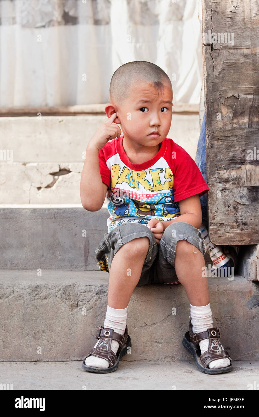 Cute boy in front of his home. Since 1979, China has a one-child policy ...