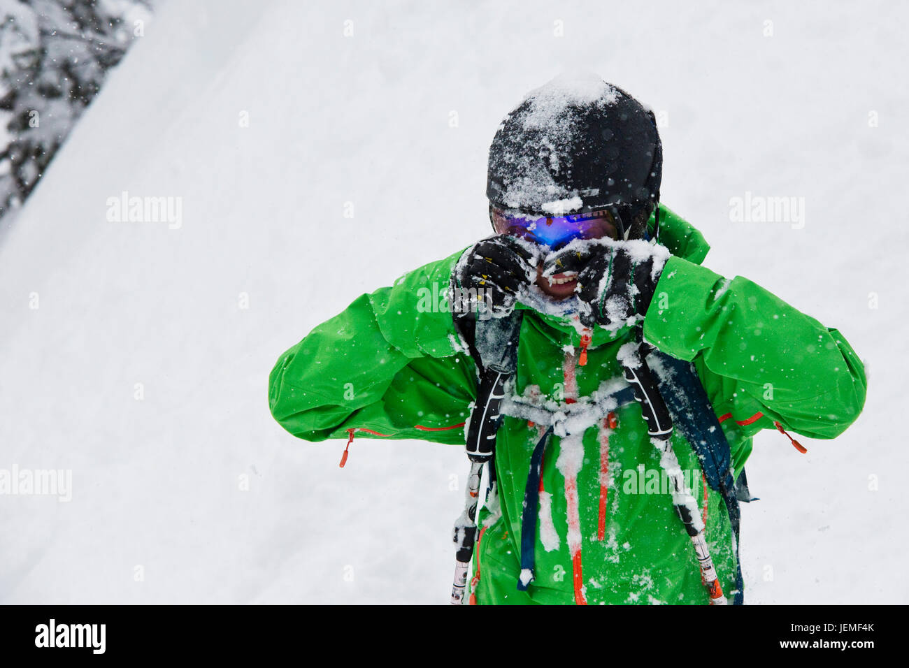 Skier cleaning goggles Stock Photo - Alamy