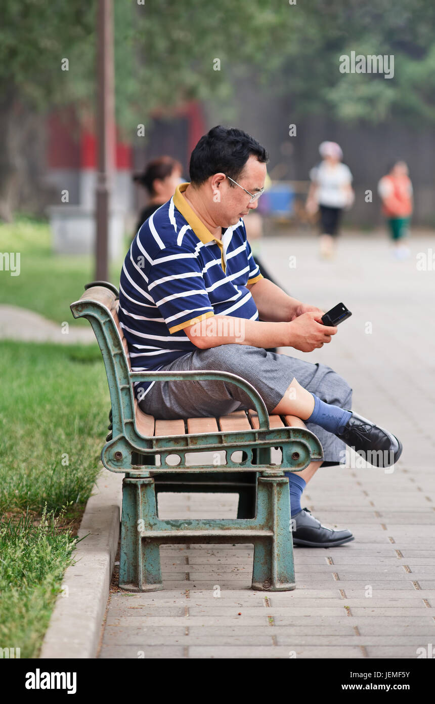 Middle aged overweight Chinese in a park. Obesity in China is a major ...