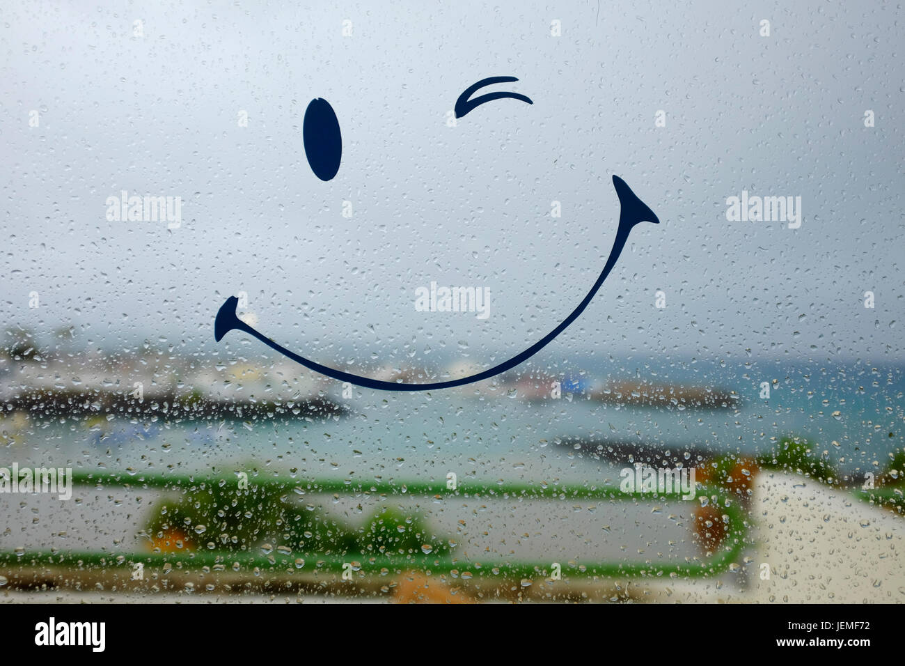 Smiley face on rainy window Stock Photo - Alamy