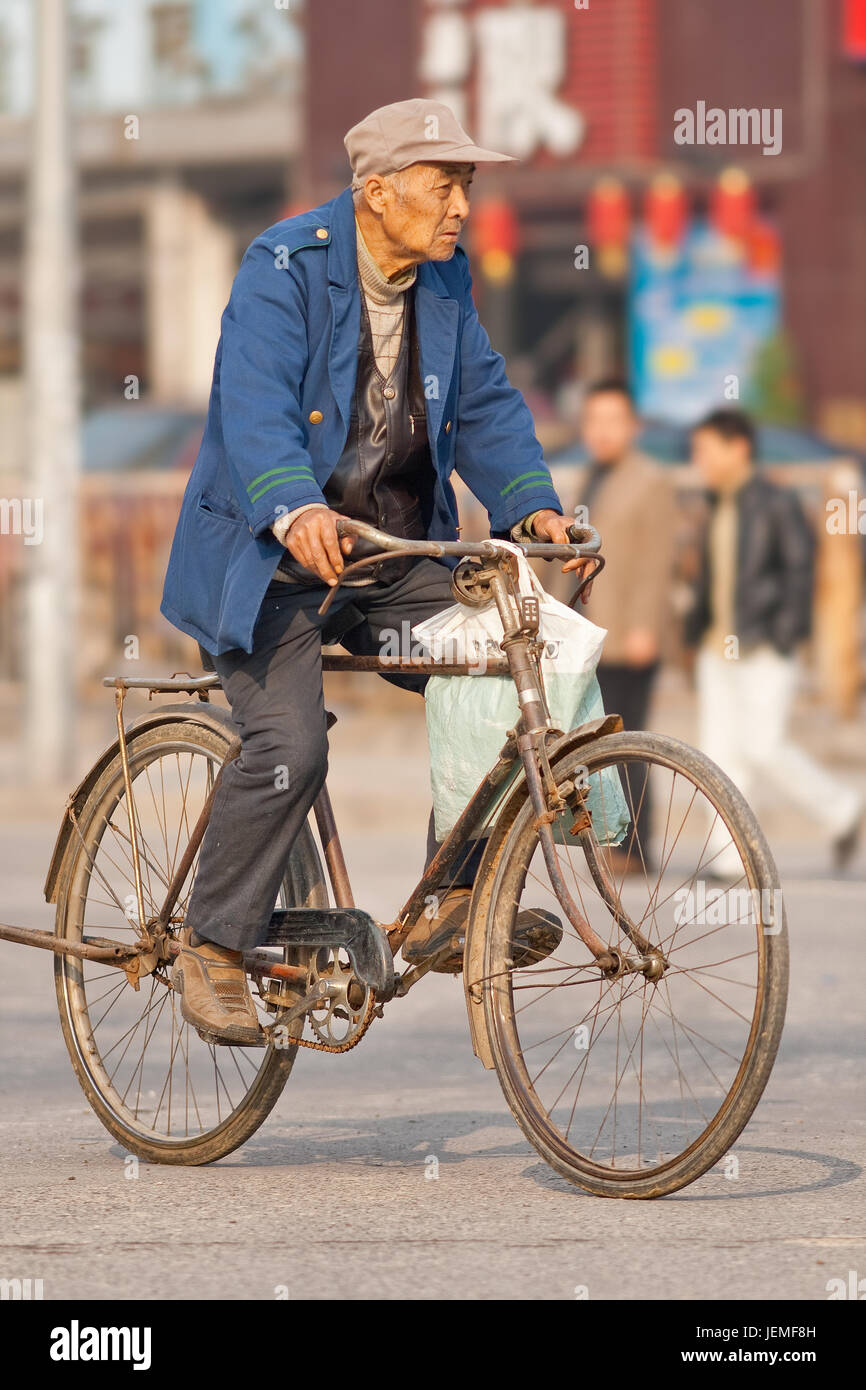 Old chinese man riding bicycle hi-res stock photography and images - Alamy