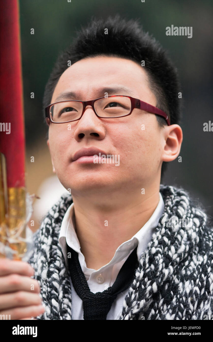 Devoted man in Buddhist temple. Buddhism have flourished in China since ...